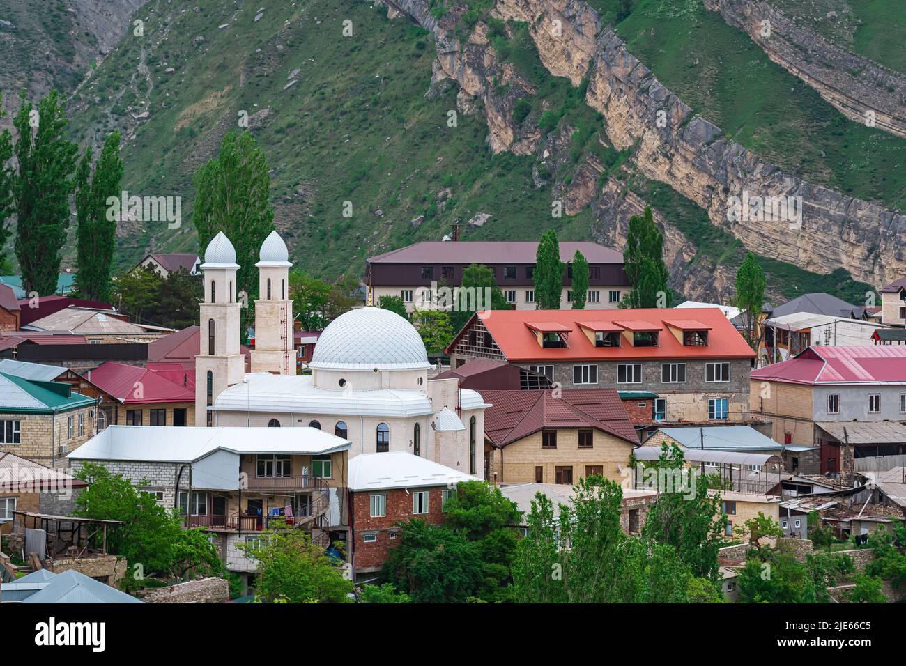 mountain village with a mosque in a valley under rock wall, Gunib town ...