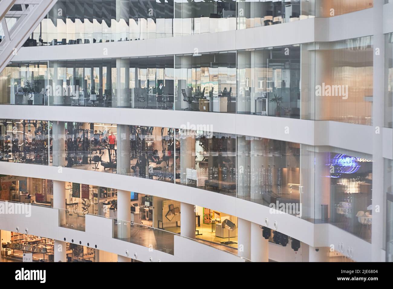 A modern shopping center with luxury brand stores. Selective focus on a multi-level bright floor ...