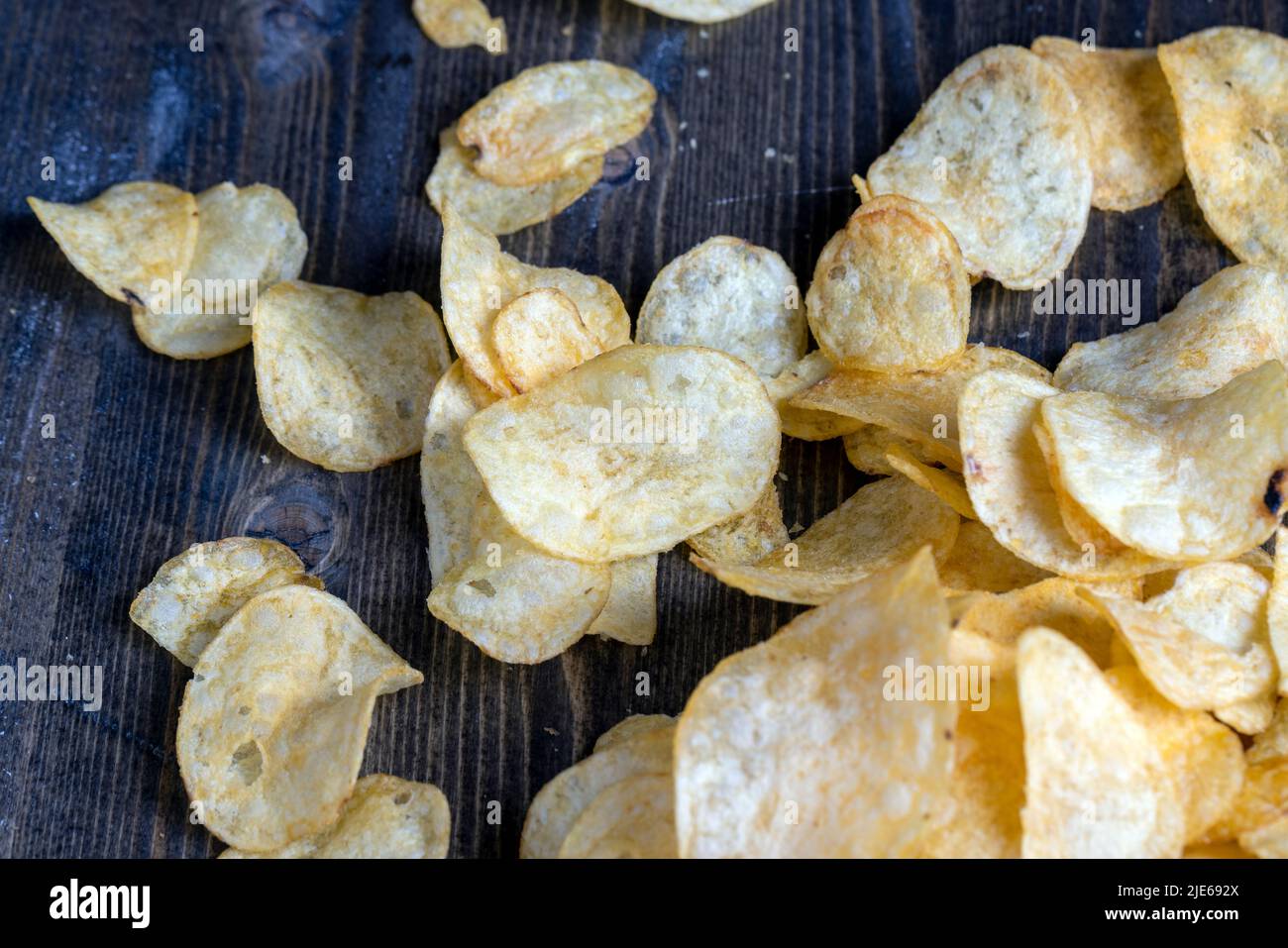 scattered potato chips with natural spices , fried potato chips with ...