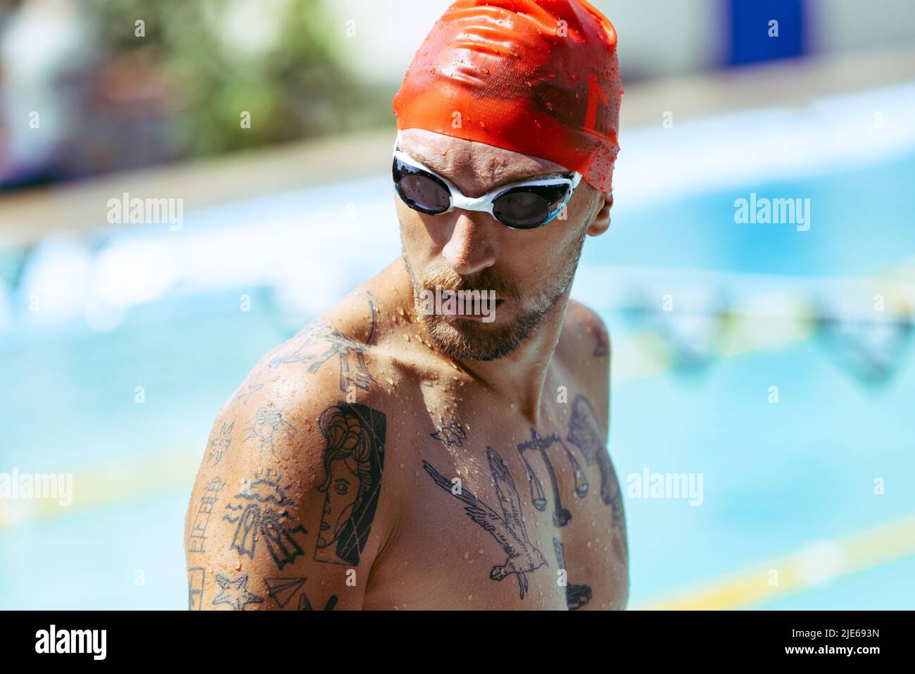 Closeup young handsome man, professional swimmer in goggles and ...