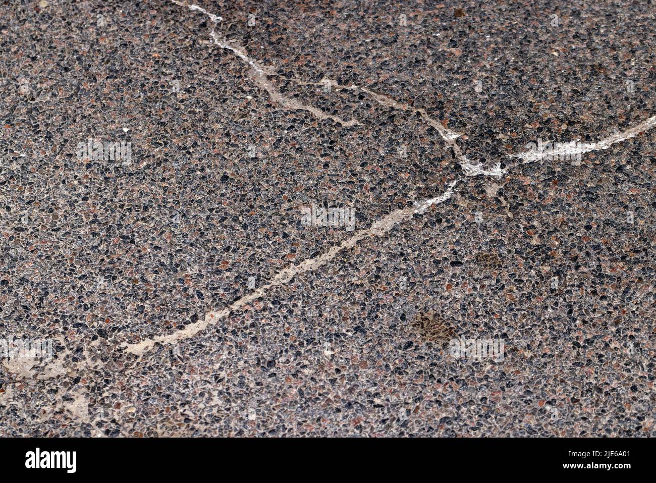 poor paved road with a lot of holes and potholes, poor transport ...