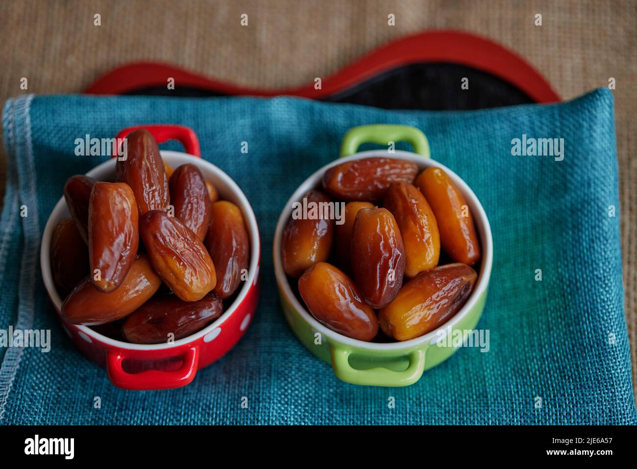 Dried dates in ceramic cup Stock Photo - Alamy