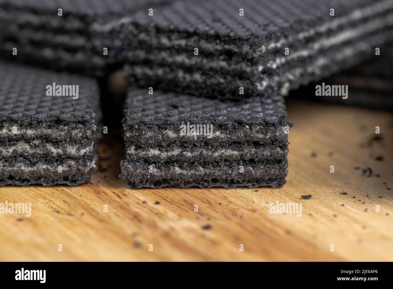 sweet dessert black waffles with creamy filling inside, laid out on a ...