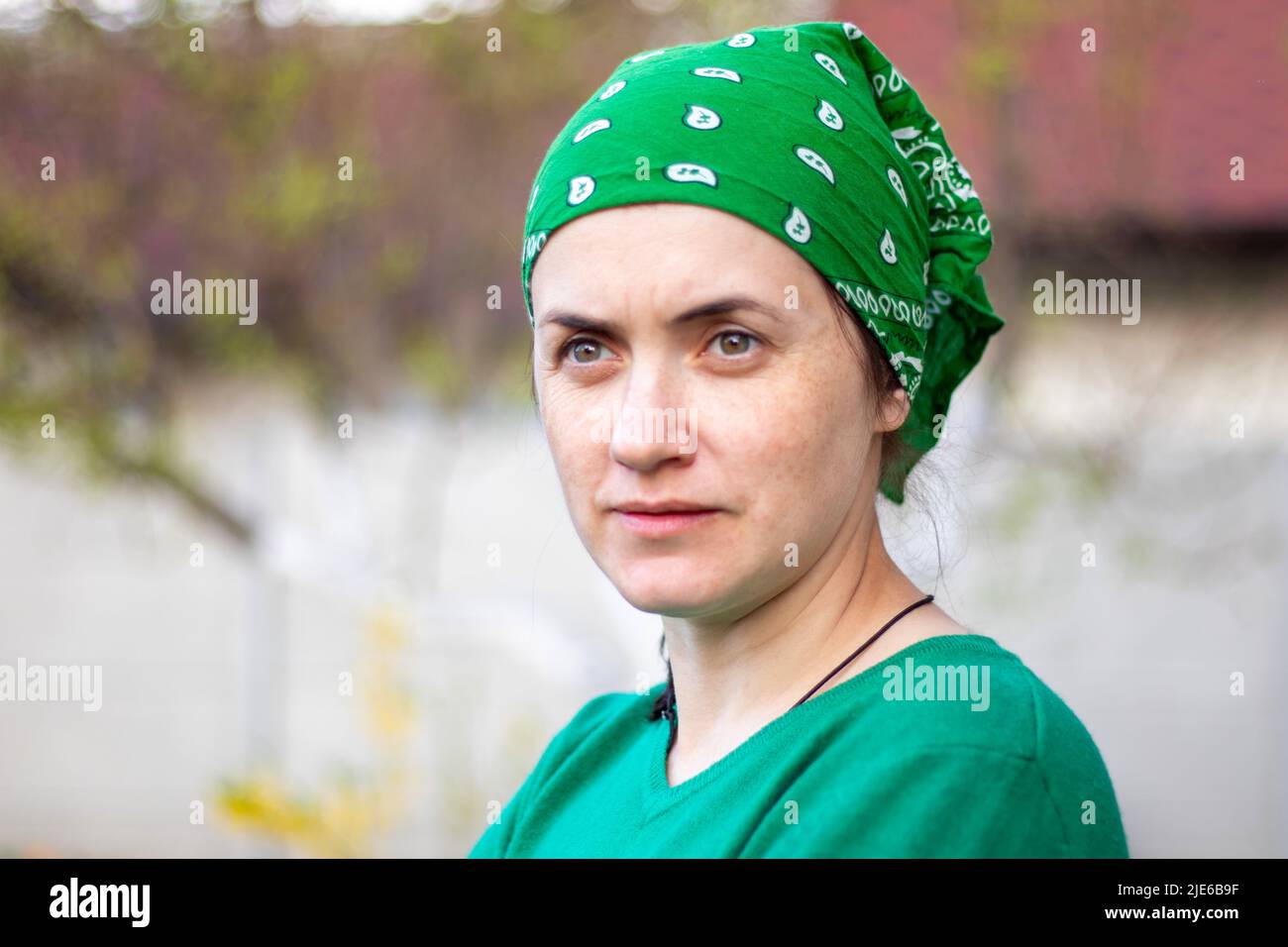 Portrait, close-up. Beautiful young woman without makeup in green t ...