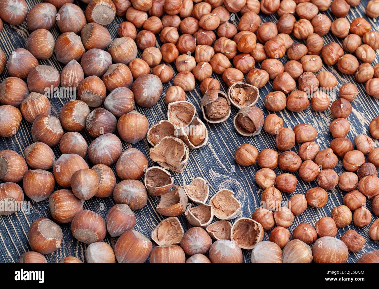 a pile of harvested hazelnuts on the table, collected a large number of ...