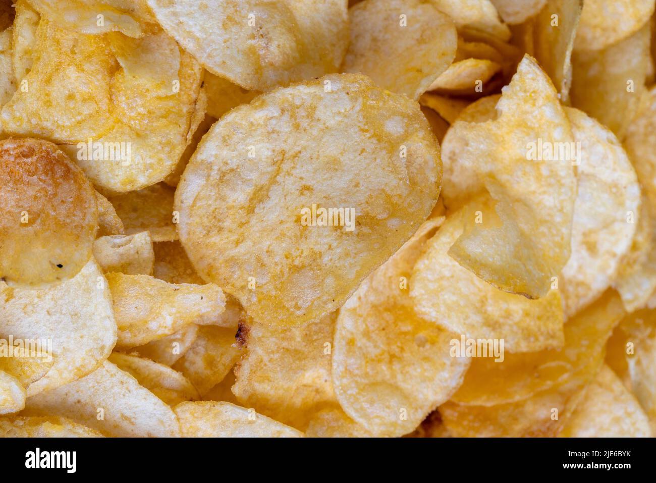 scattered potato chips with natural spices , fried potato chips with ...