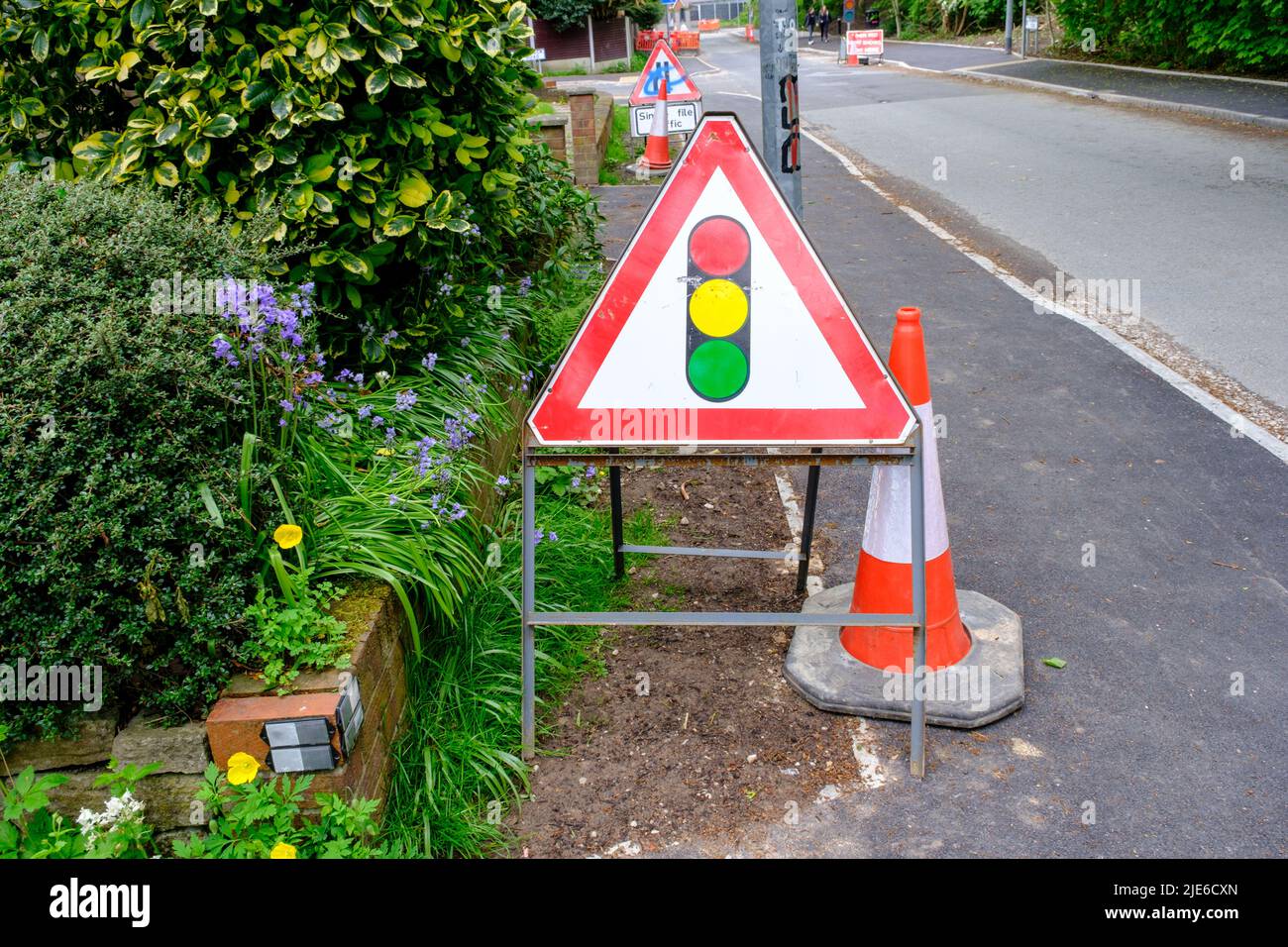Traffic lights warning triangle sign on road in UK Stock Photo - Alamy