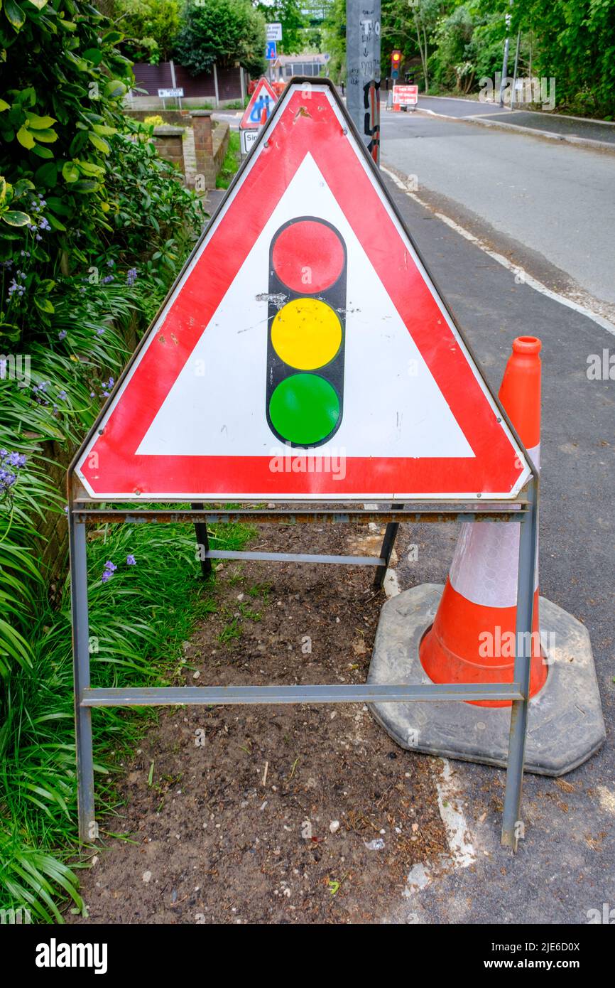 Traffic lights warning triangle sign on road in UK Stock Photo - Alamy