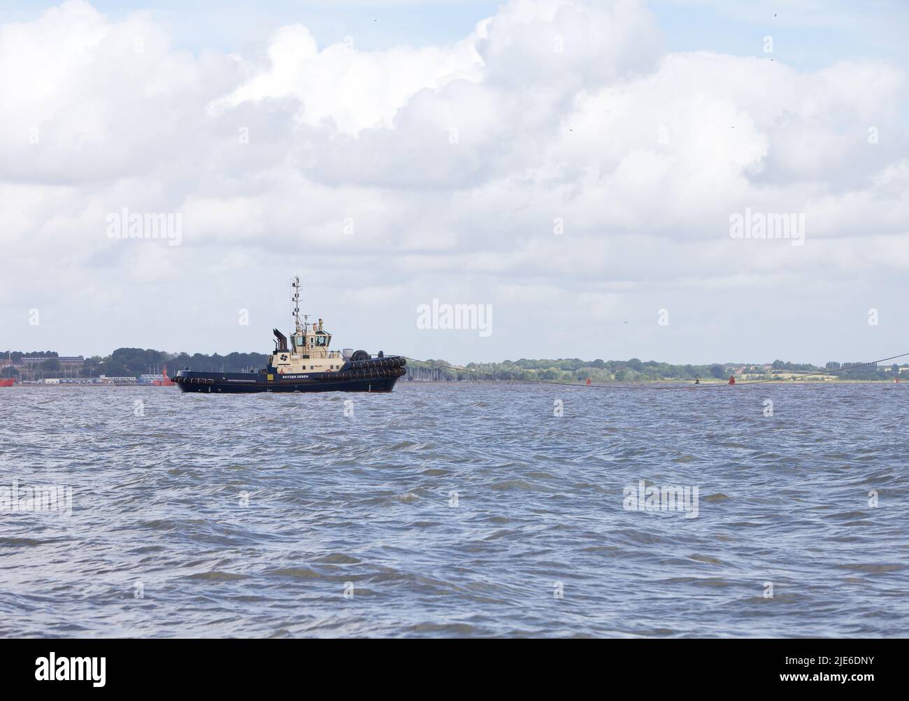 Tugboat Svitzer Deben assisting a container ship to dock at the Port of ...