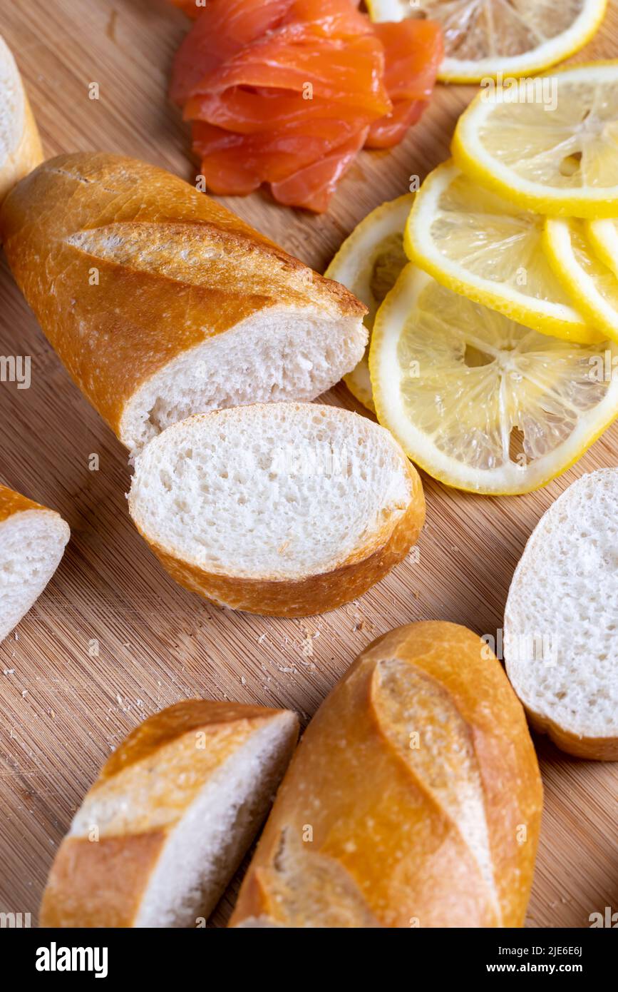 sliced red salted salmon during cooking, cutting fish fillets during ...