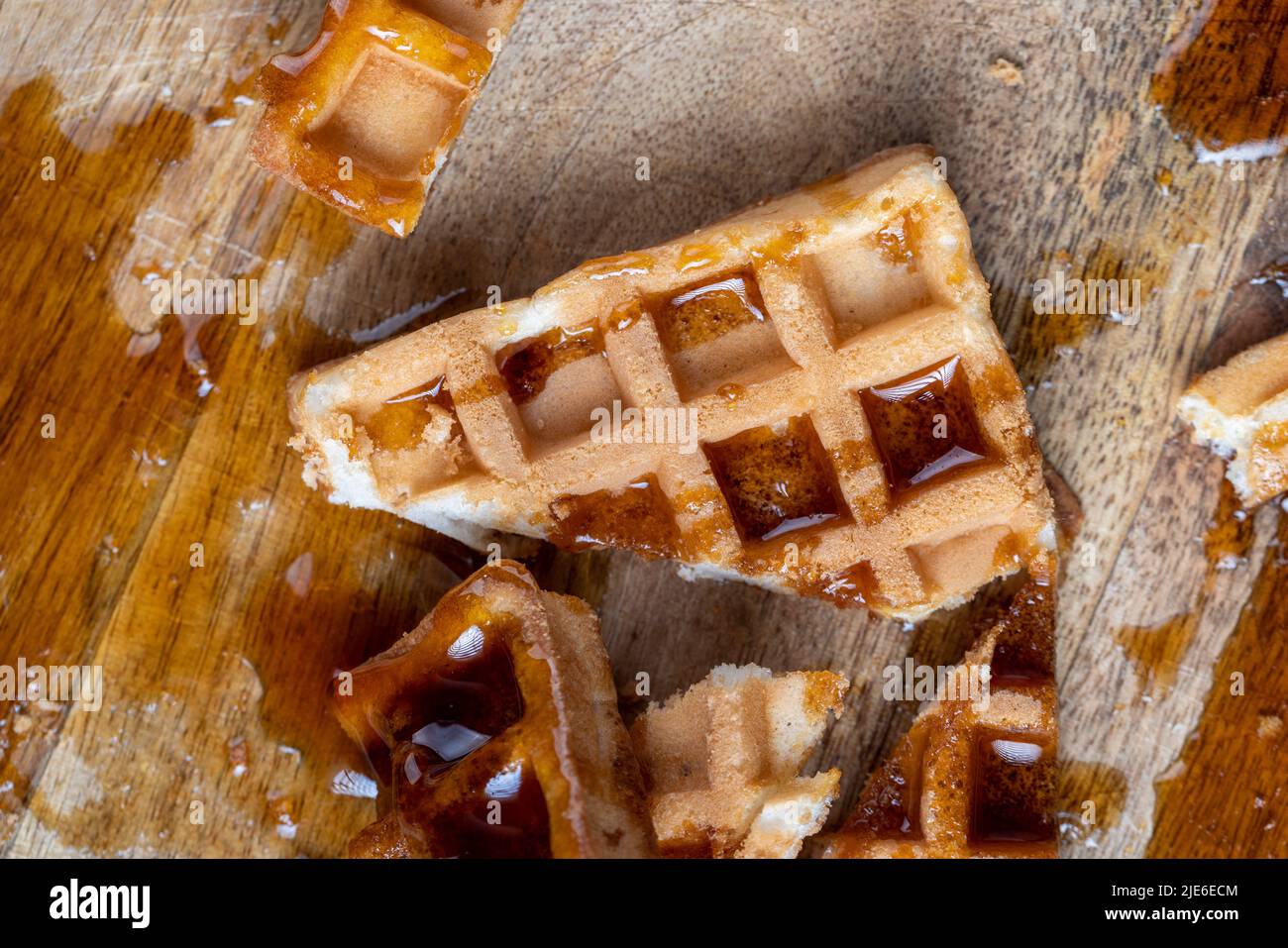square sweet soft waffles in bee honey , a traditional European dessert ...