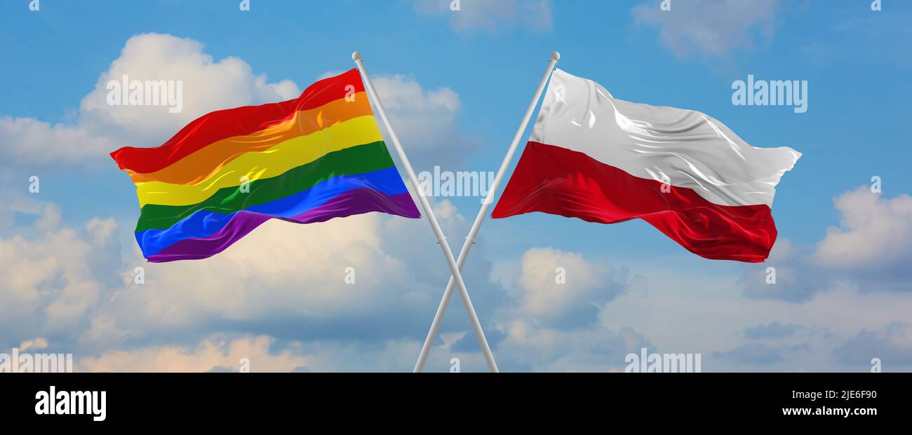 two crossed flags LGBT Pride and Poland waving in wind at cloudy sky ...