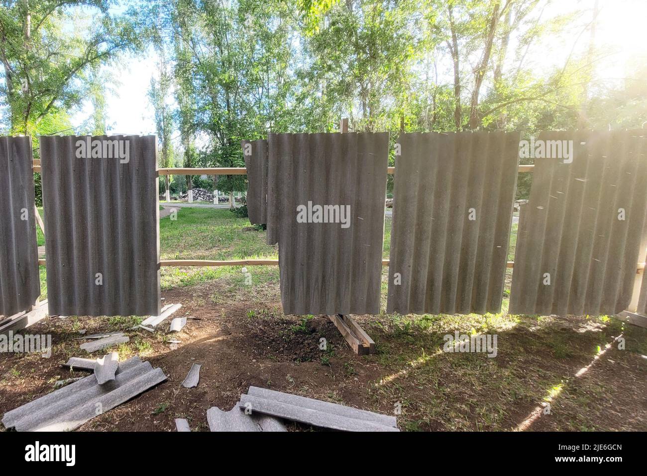 Broken slate fence with huge hole around the construction site Stock ...