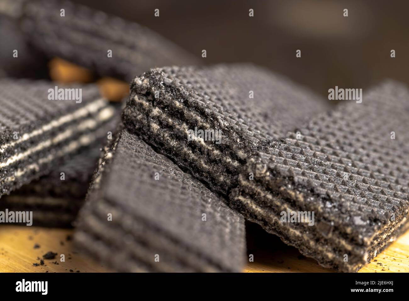 sweet dessert black waffles with creamy filling inside, laid out on a ...