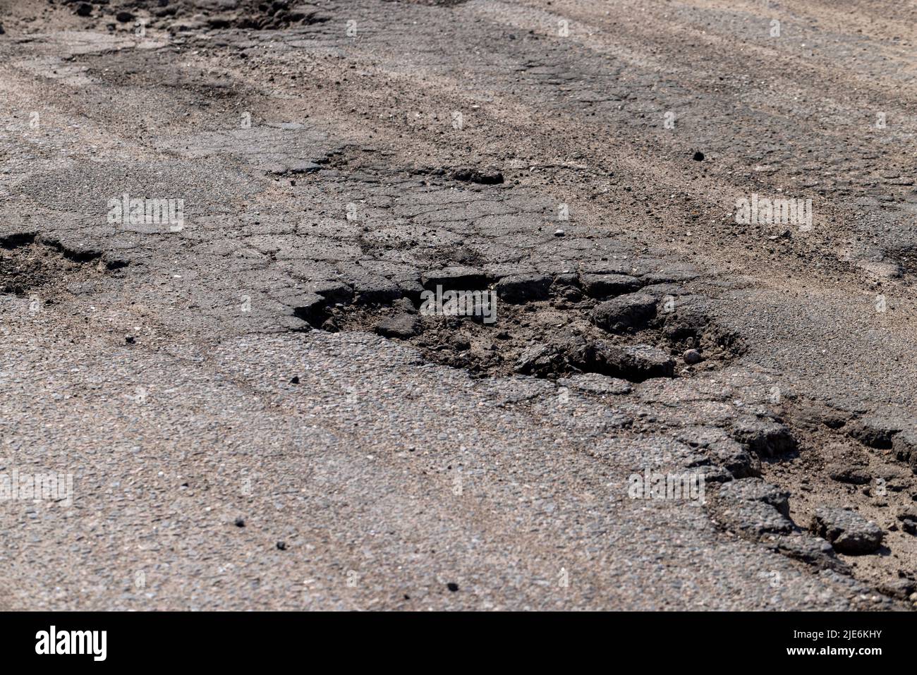 poor paved road with a lot of holes and potholes, poor transport ...