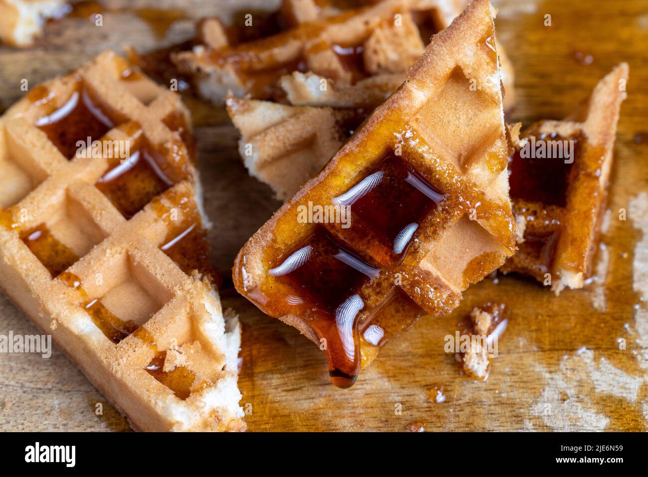 square sweet soft waffles in bee honey , a traditional European dessert ...