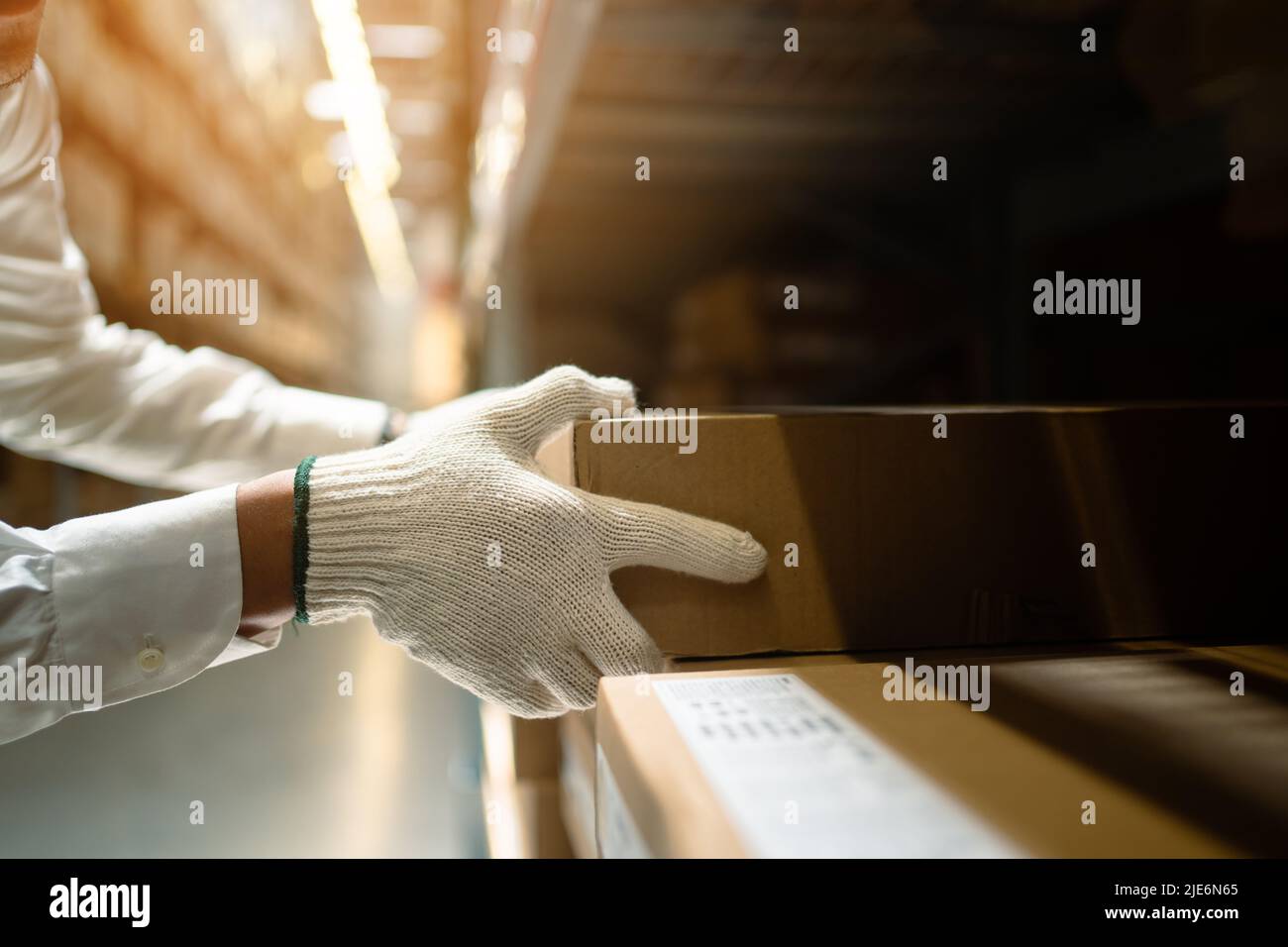 Security concept and parcel box hand held over large warehouse ...