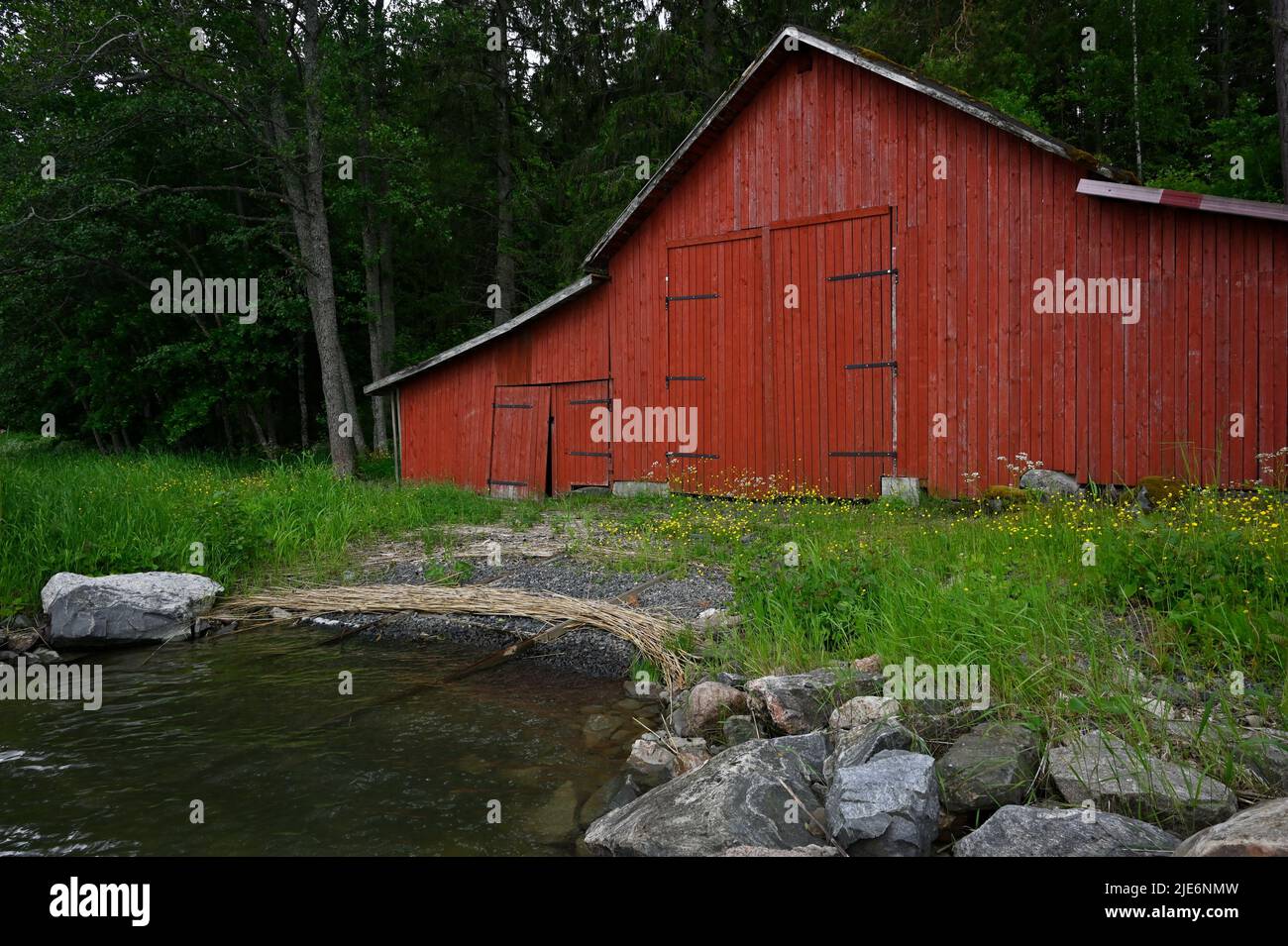 traditional old red finnish boathouse by the lake Stock Photo - Alamy