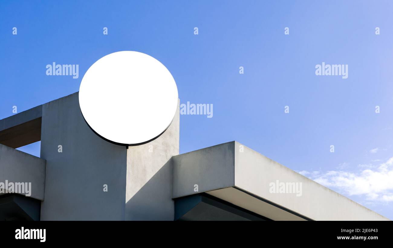 Blank circle sign mockup in the urban environment, on the facade, empty ...
