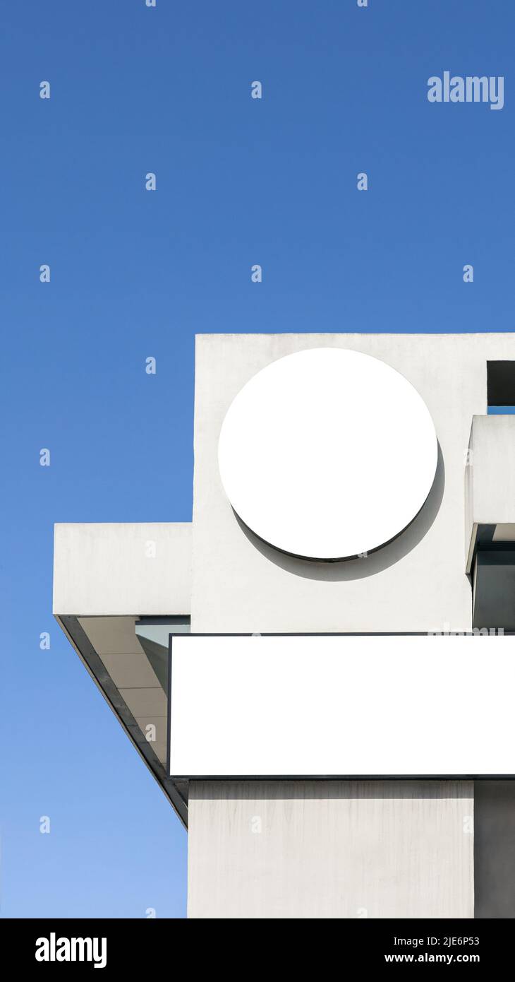 Blank circle sign mockup in the urban environment, on the facade, empty ...