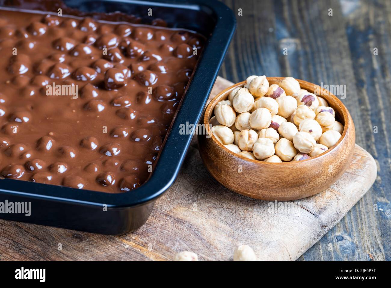 real milk chocolate while cooking with hazelnuts, a bunch of hazelnuts ...