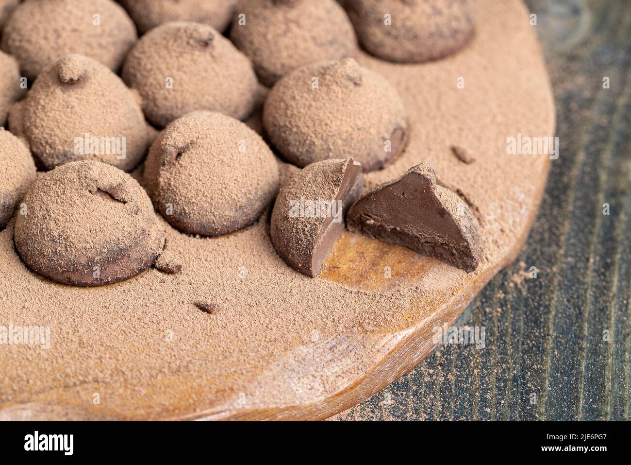 chocolate candies truffles on a wooden board, a bunch of chocolates ...