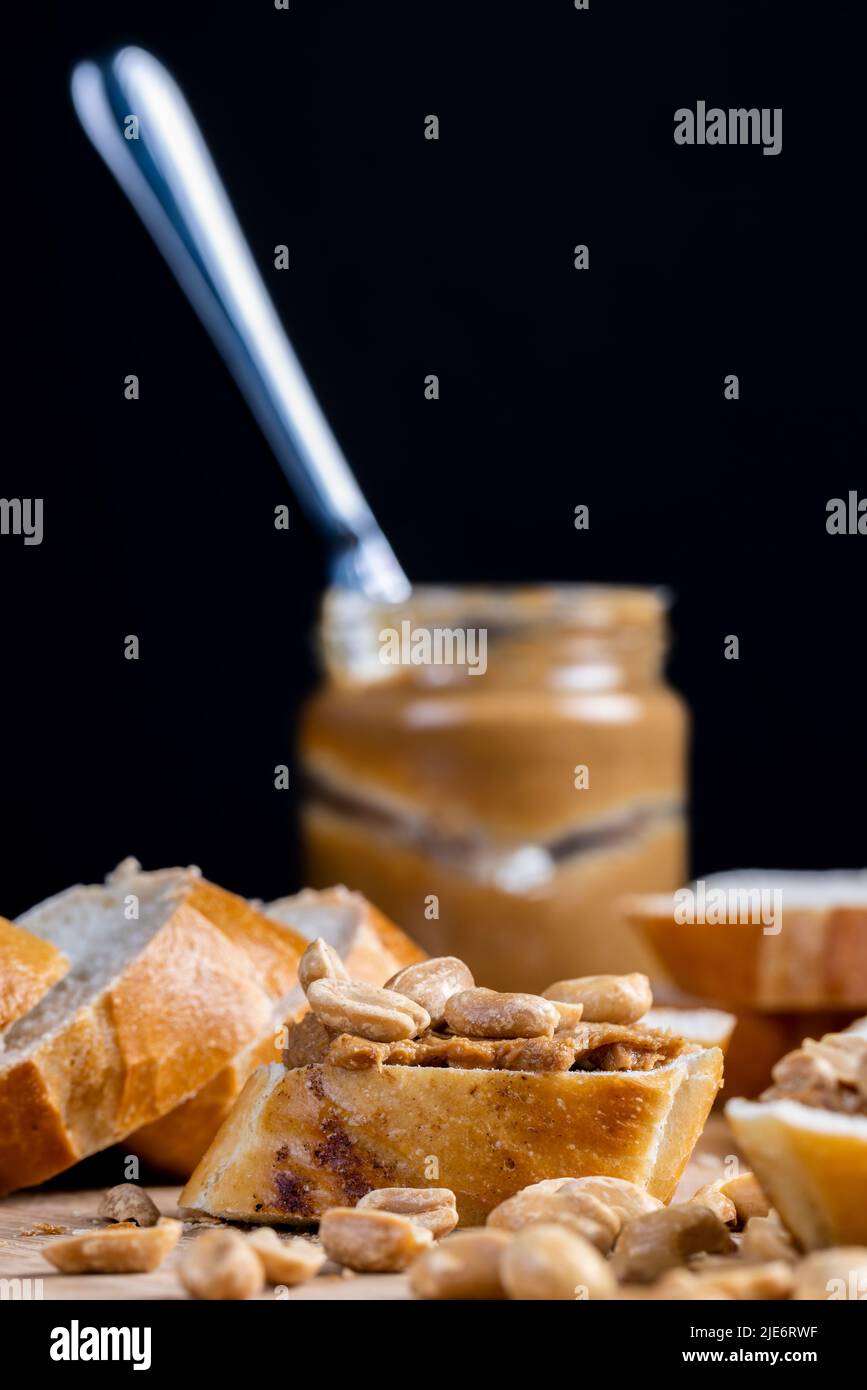 wheat fresh baguette and peanut paste, making breakfast of bread and ...