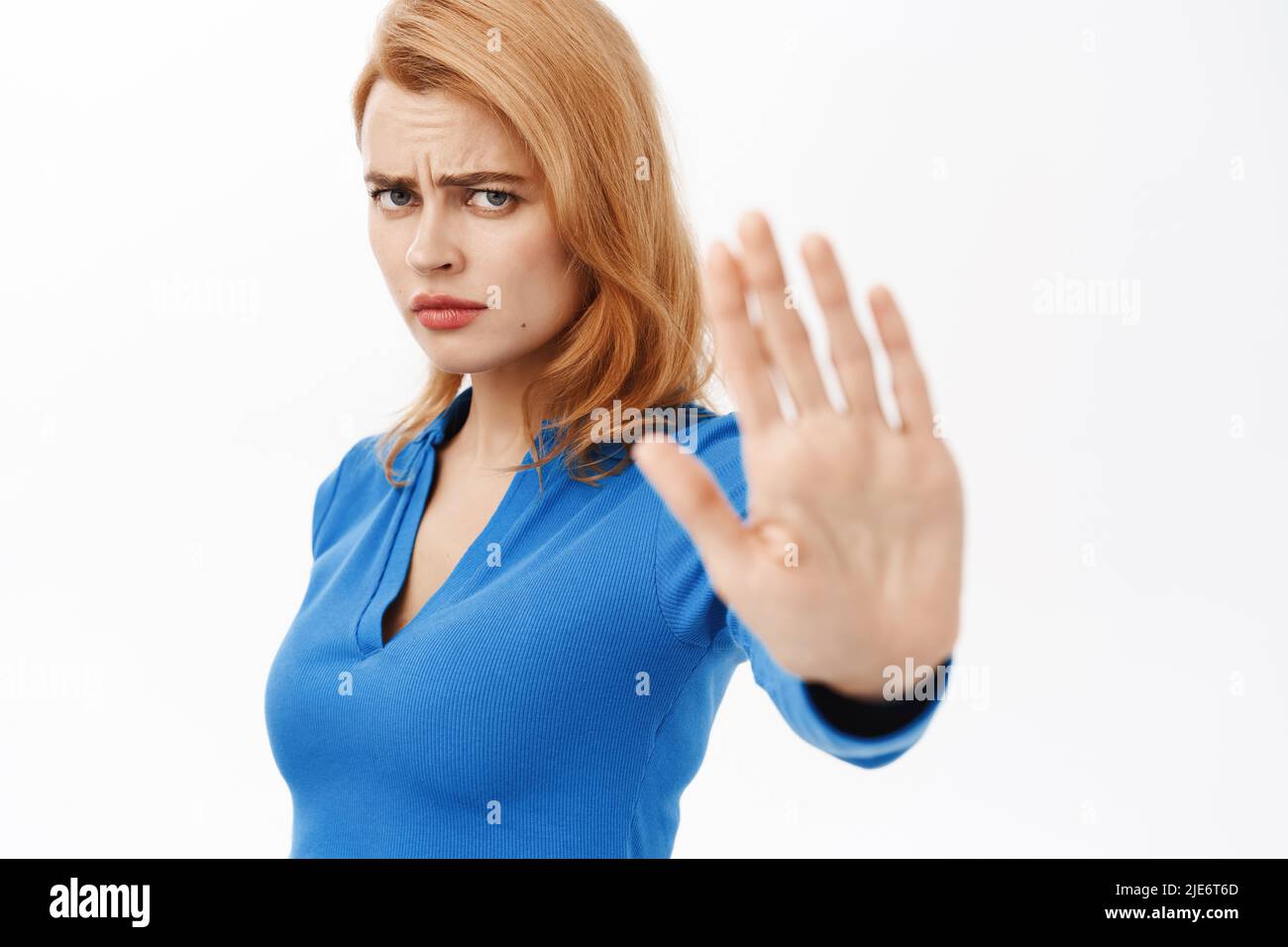 Portrait of girl extending her palm, saying no, dislike smth, prohibit ...