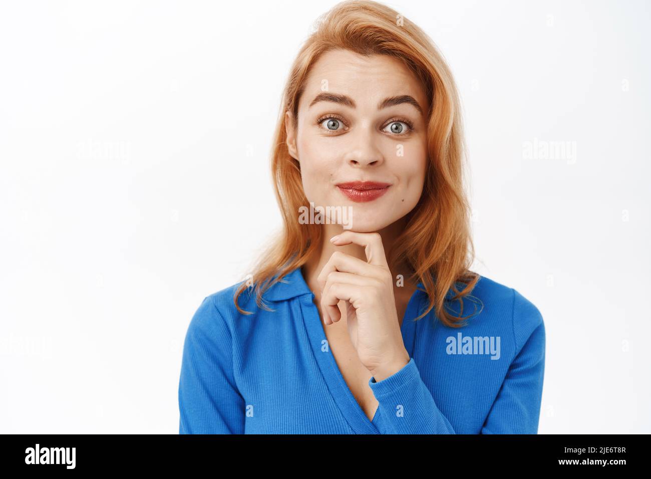 Portrait of young woman listetning with interest, looking intrigued ...
