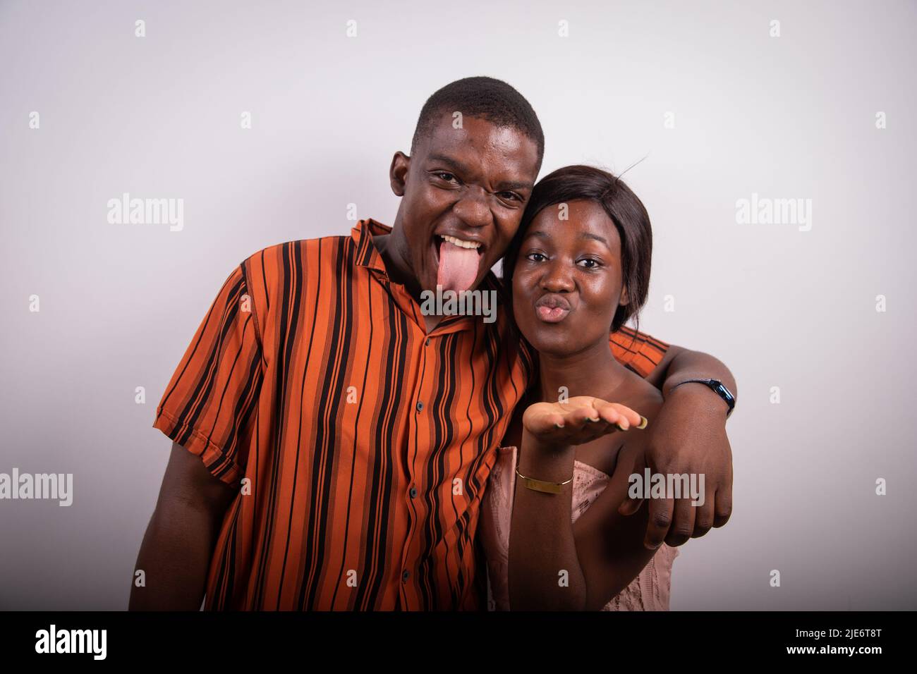 Young couple of friends embraced, having fun in the photo studio ...