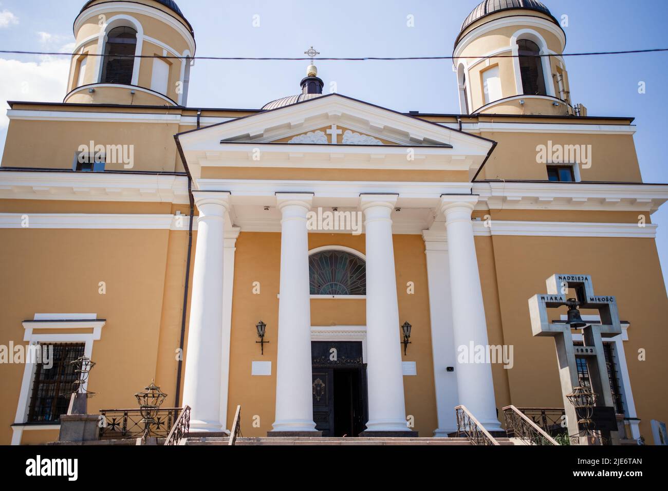 an entrance to a large catholic church with white columns Stock Photo ...