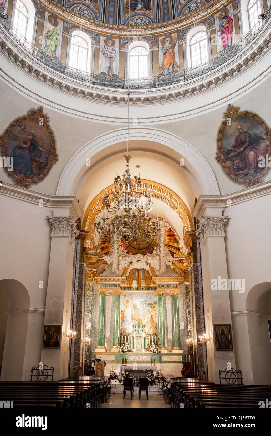 interior of beautiful catholic church with benches icons and ...