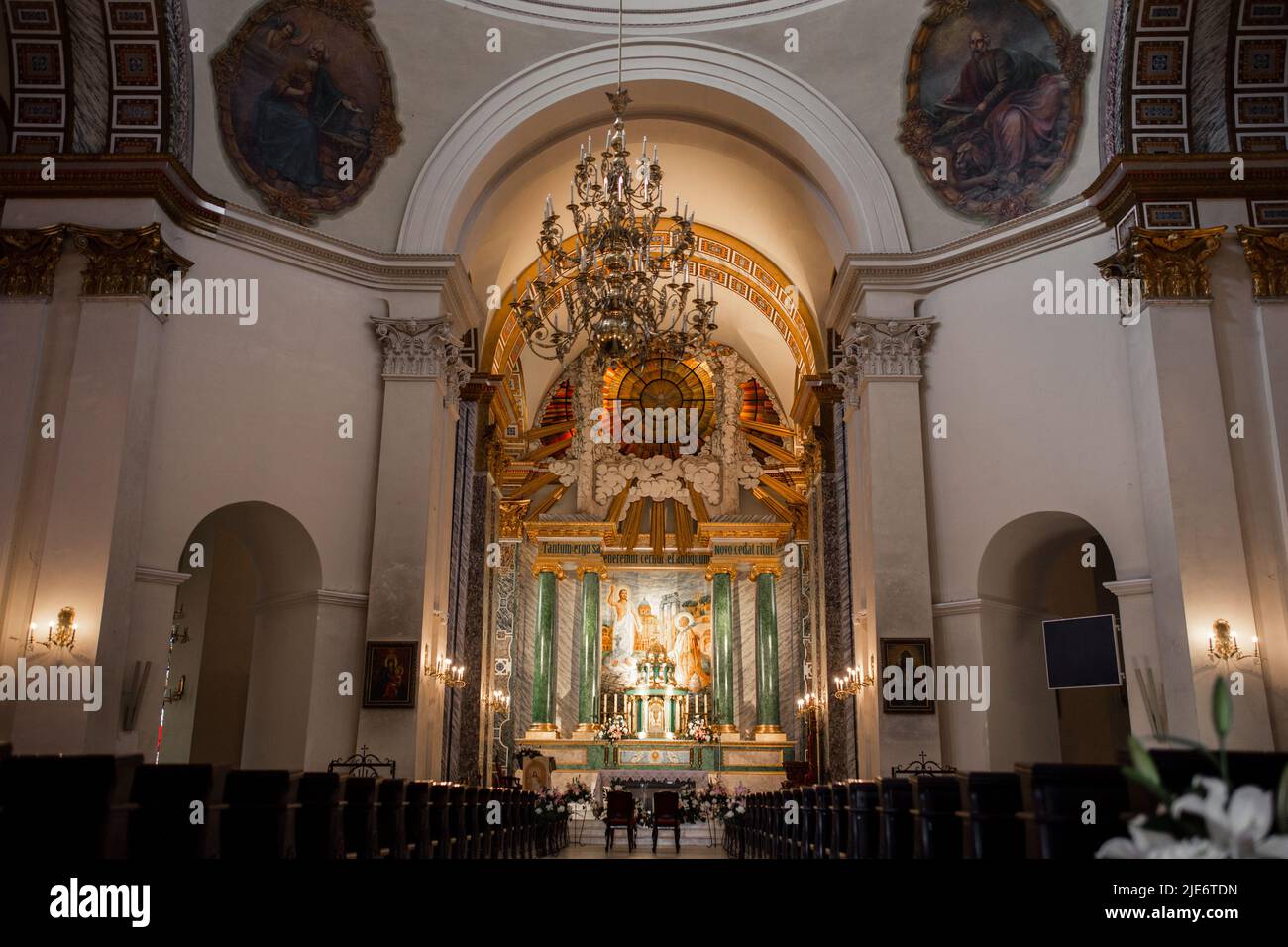 interior of beautiful catholic church with benches icons and ...
