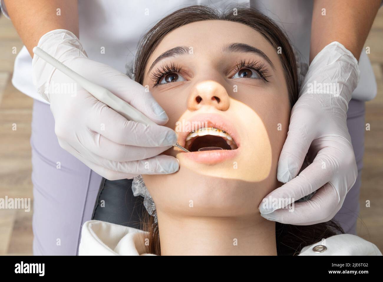 Dentist examining patient teeth with mirror in dentist clinic Stock ...