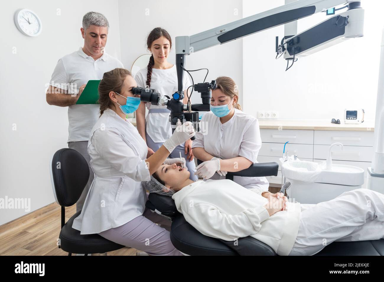 Group of students in dental clinic learn watching dental treatment with ...