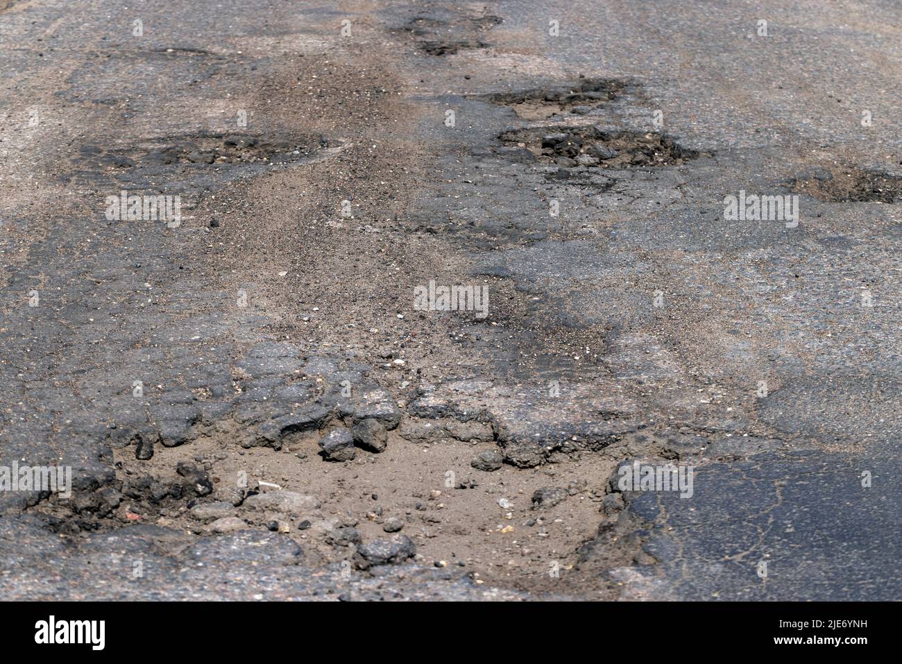 poor paved road with a lot of holes and potholes, poor transport ...