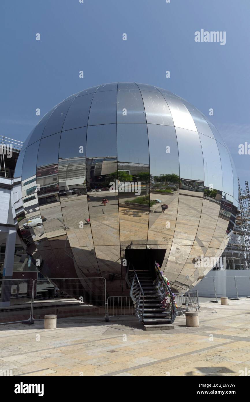 The Millennium Sphere reflecting blue sky and fluffy clouds in ...