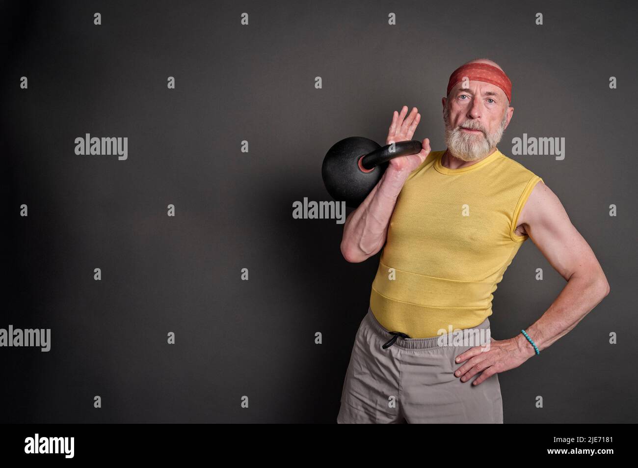 Athletic Senior Man Is Training With A Heavy Iron Kettlebell Fitness