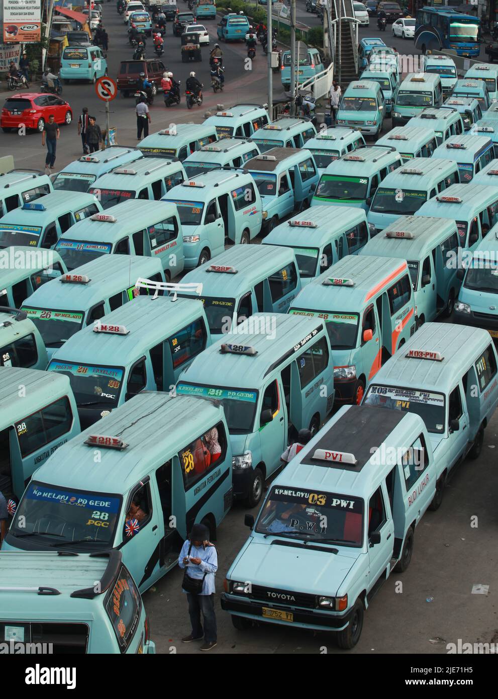 a row of microbus angkots at the Kampung Melayu terminal, Jakarta ...