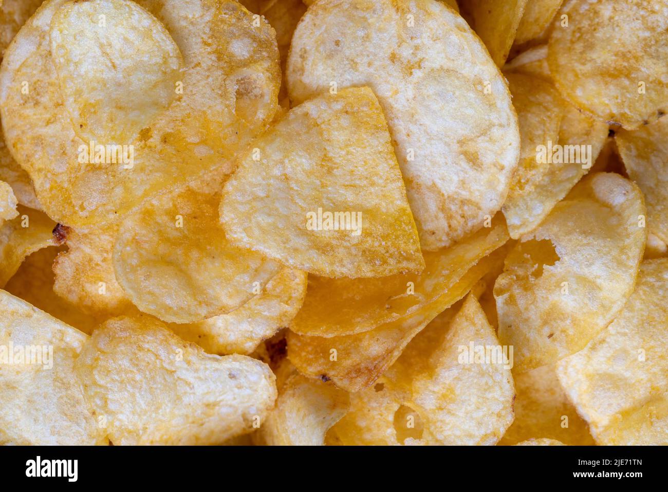 scattered potato chips with natural spices , fried potato chips with ...