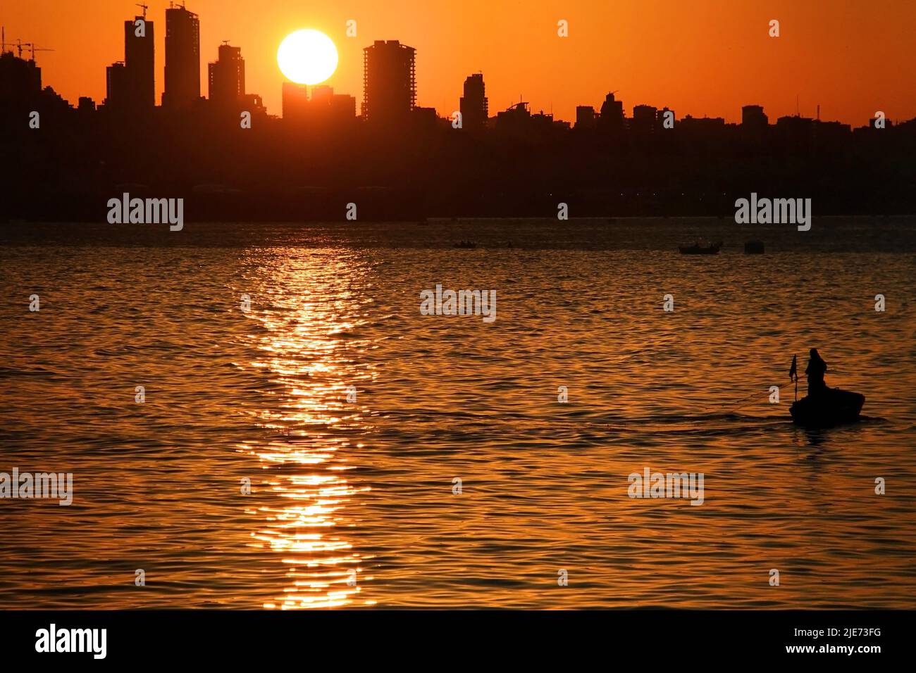 The setting sun between the buildings of Beirut, Lebanon Stock Photo ...