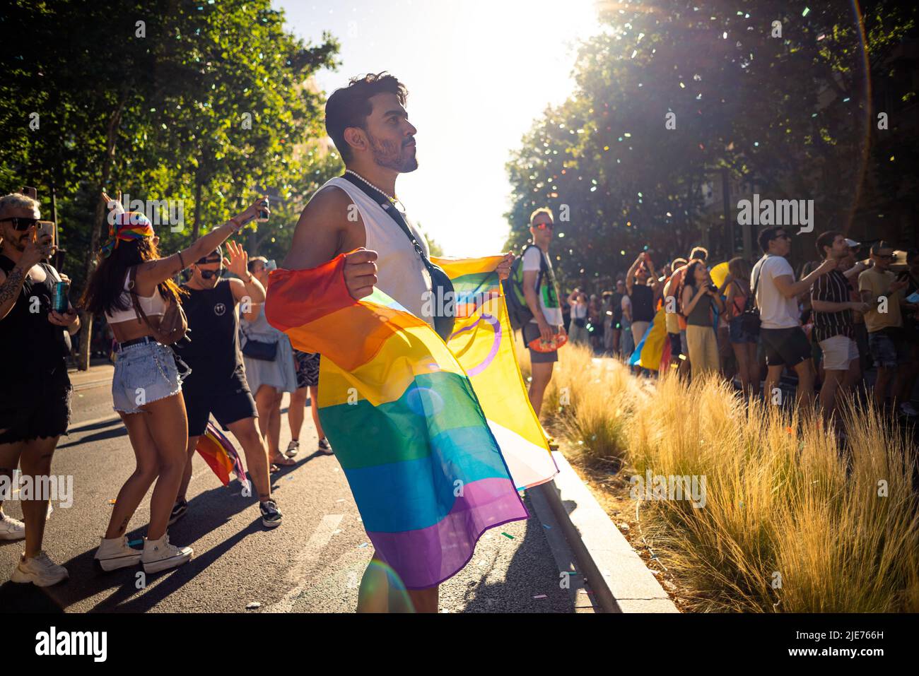 People holding rainbow flags and banners are seen marching during the ...