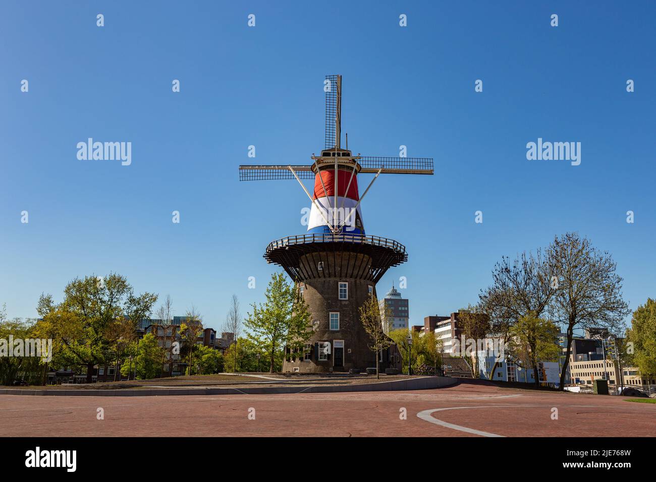 Historical Dutch windmil Molen de Valk with Dutch flag in Leiden, The ...