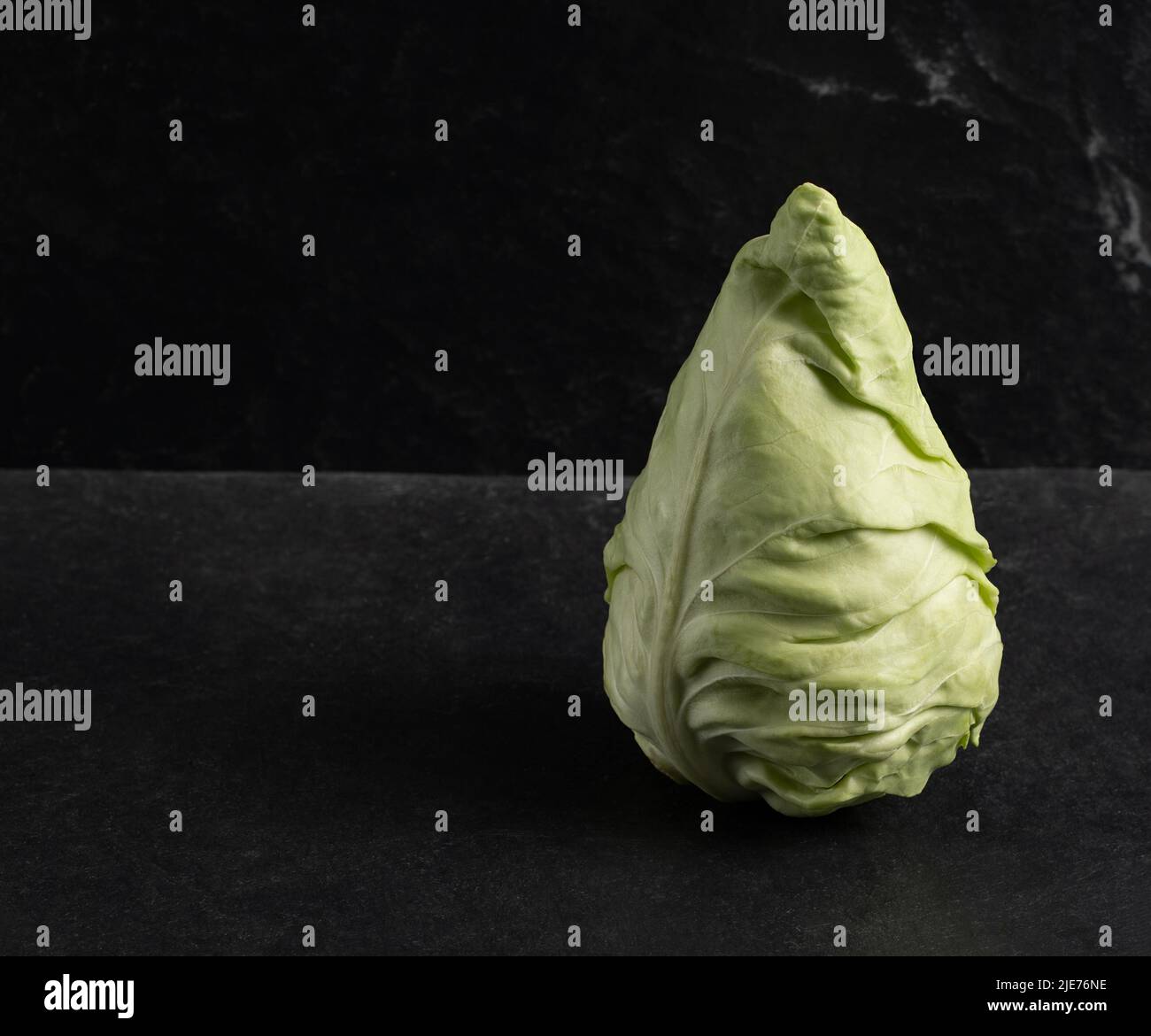 Cone head cabbage for dietary, vegan on a black background Stock Photo ...
