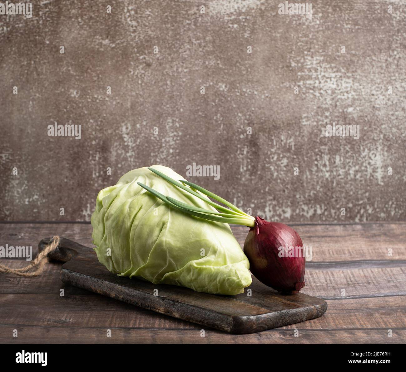 Cone head cabbage and red onion for dietary, vegan on a grey background ...