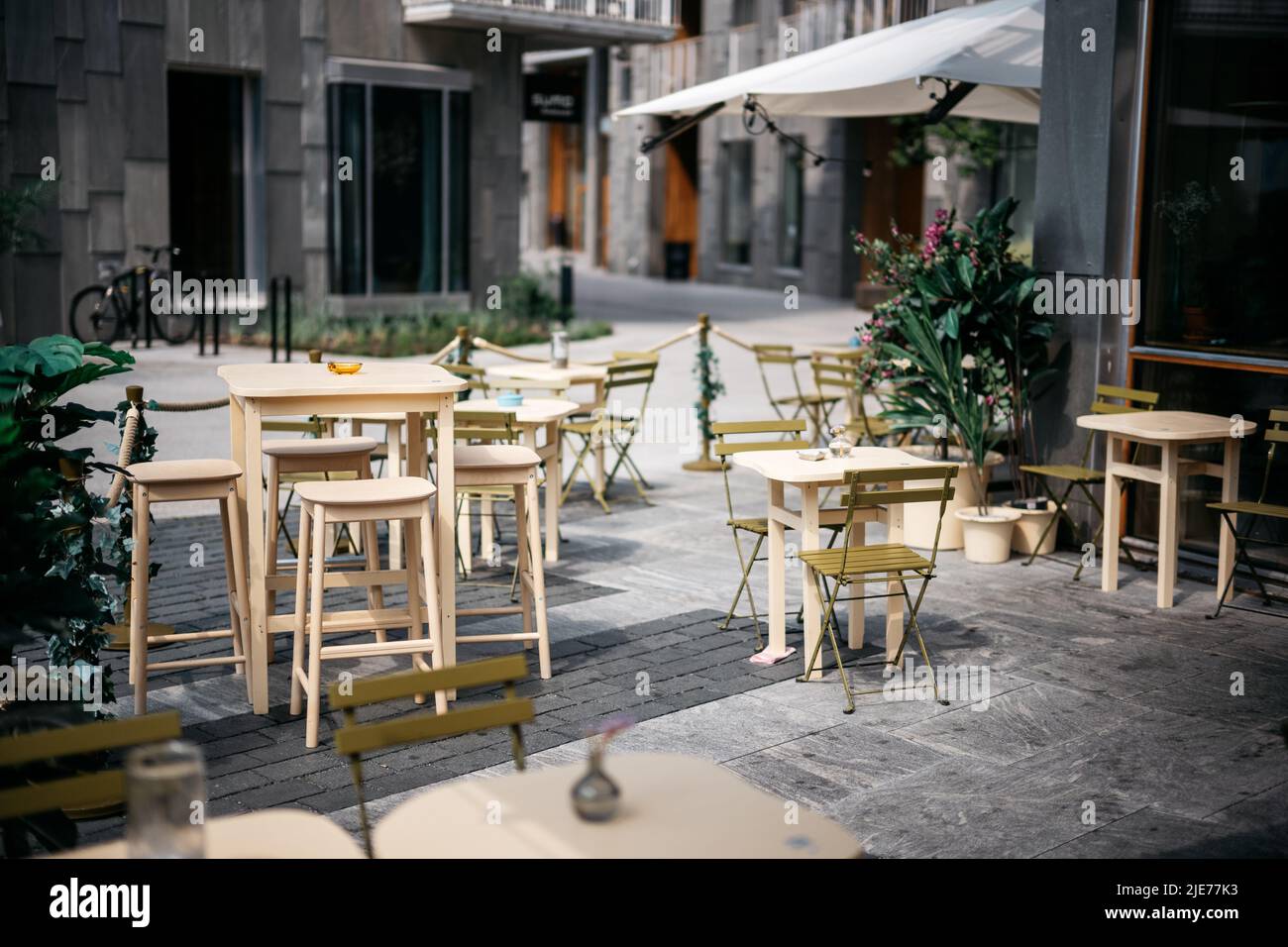 Wooden chairs and tables in an outdoor restaurant Stock Photo - Alamy