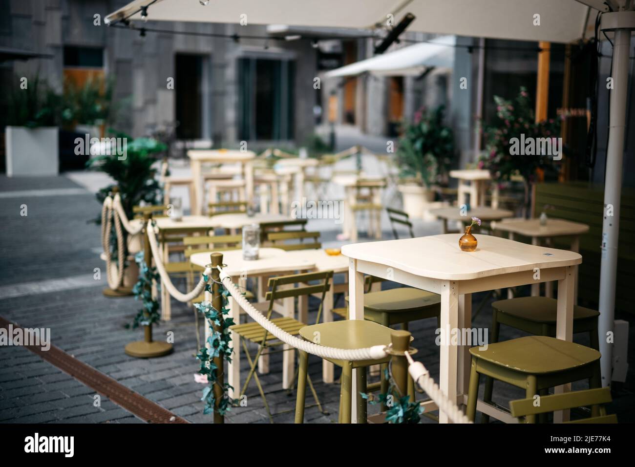 Wooden chairs and tables in an outdoor restaurant Stock Photo - Alamy