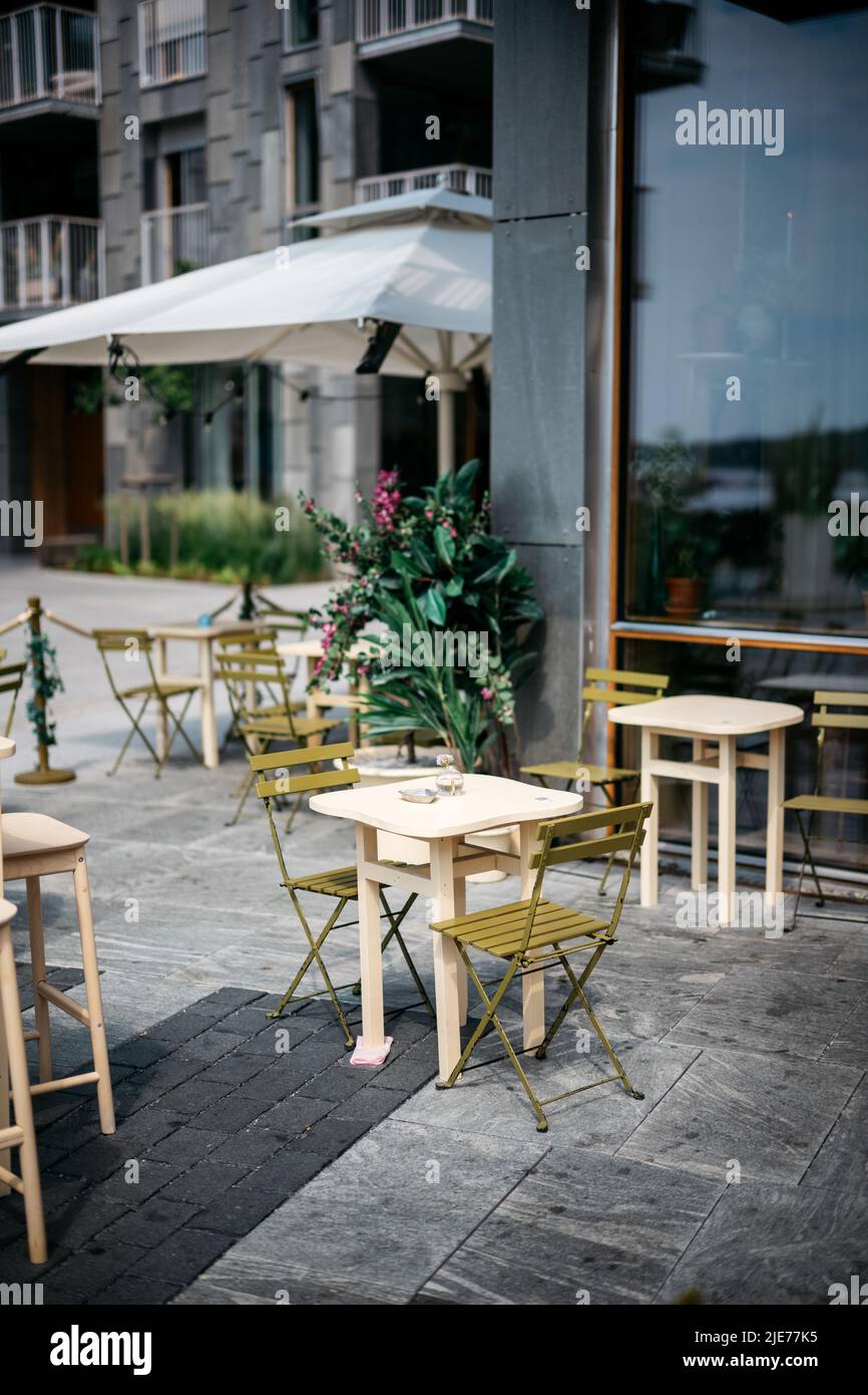 Wooden chairs and tables in an outdoor restaurant Stock Photo - Alamy