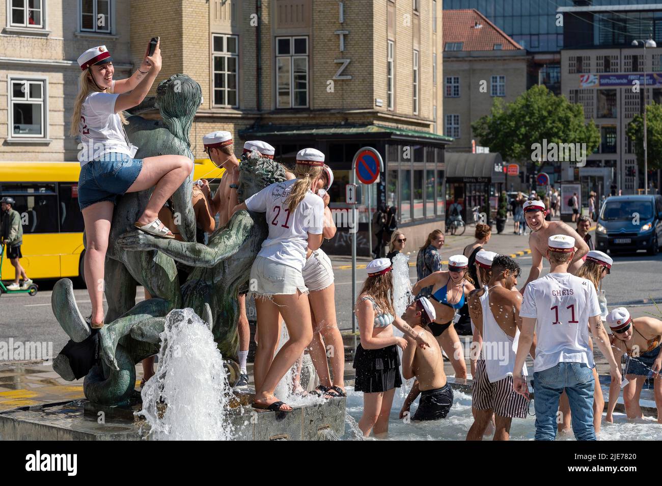 Students in a fountain celebrating graduating from high school in ...