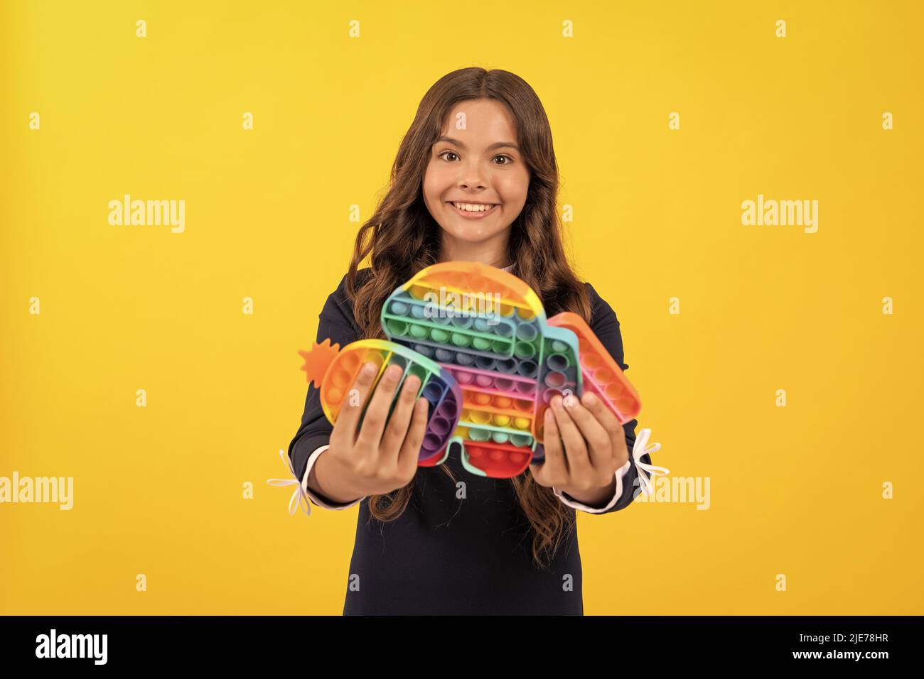 happy kid holding many pop it or popit silicone sensory fidget toys ...